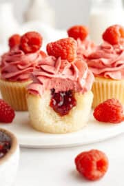 Easy Raspberry Almond Cupcakes with Raspberry Jam Filling - Alpine Ella